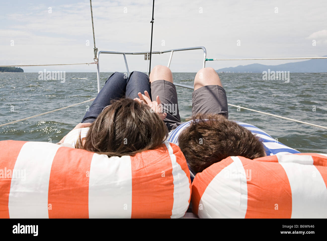 Couple relaxing on a boat Stock Photo - Alamy