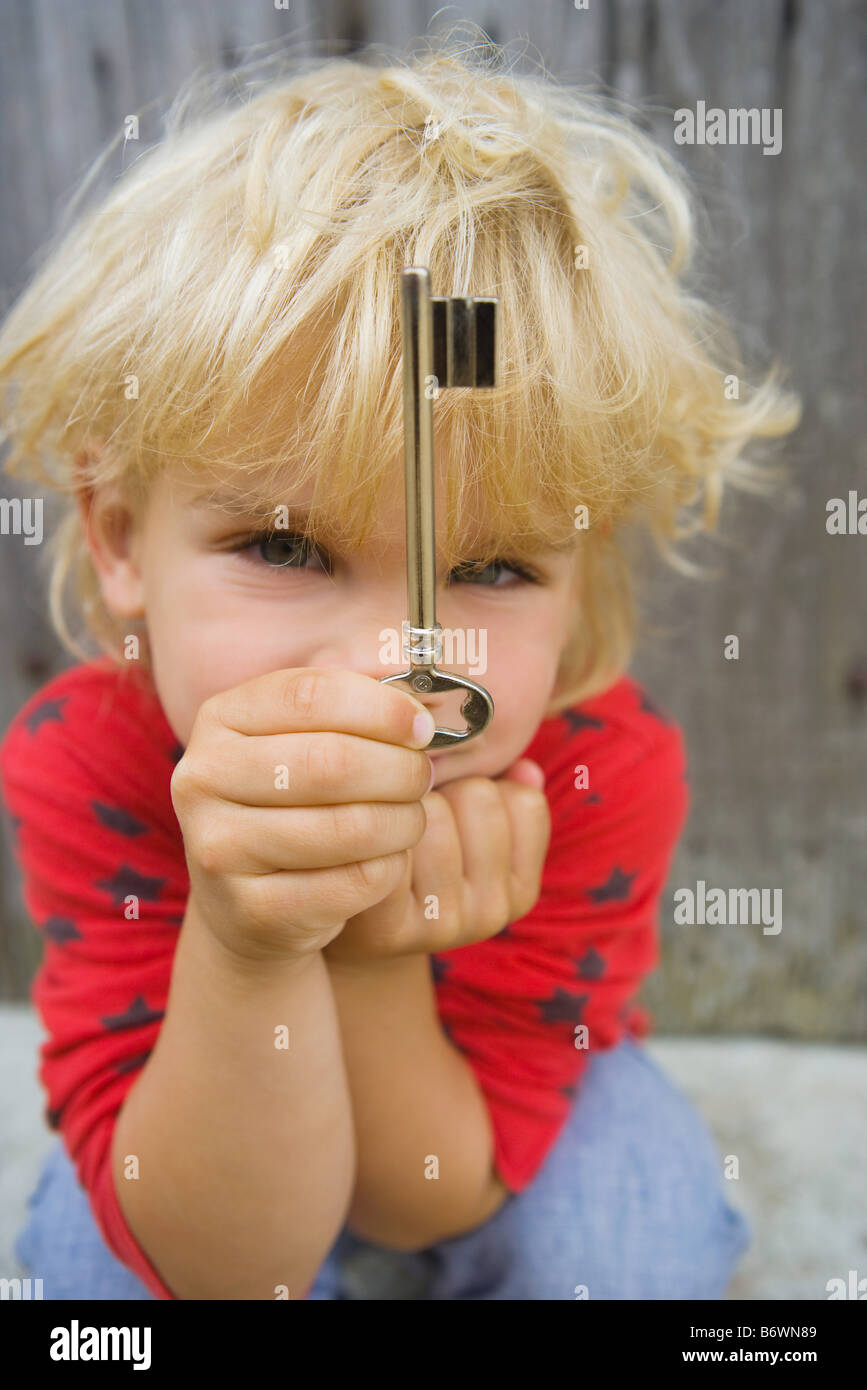 Portrait of a boy holding a key Stock Photo - Alamy