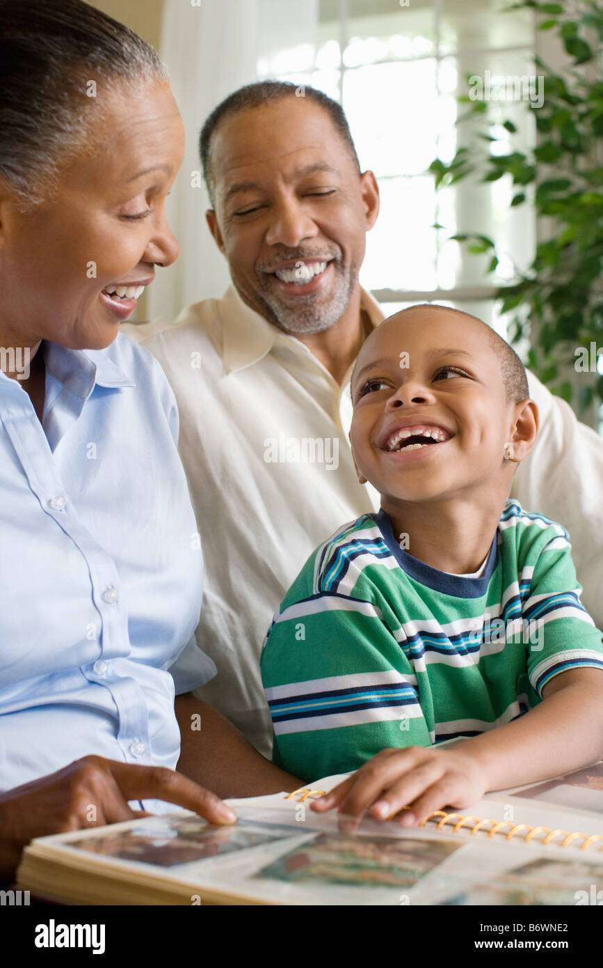 Grandparents and their grandson looking at a photo album Stock Photo ...
