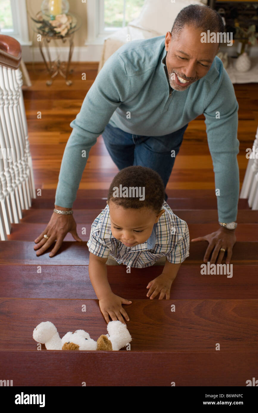 A grandfather watching his grandson climb the stairs Stock Photo - Alamy