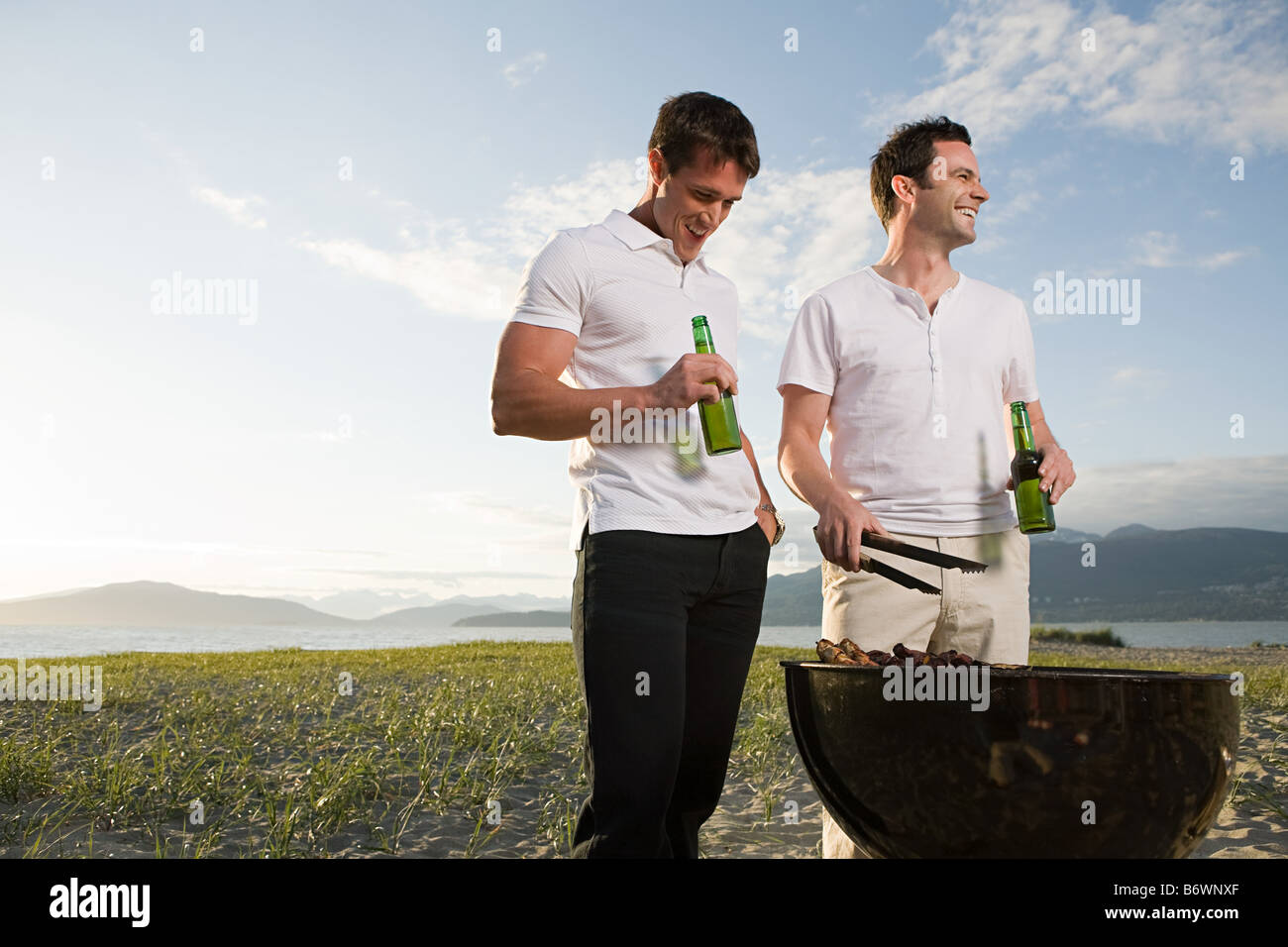 Men barbecuing on an island Stock Photo - Alamy