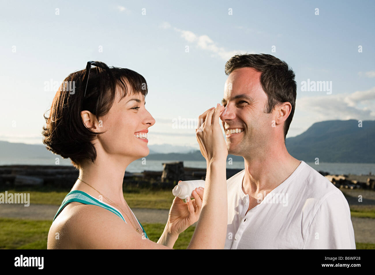 Man applying suntan lotion woman hi-res stock photography and images ...