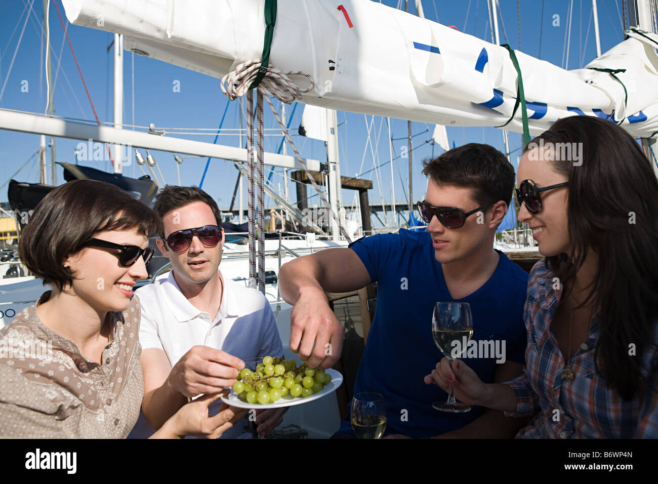 Friends eating grapes on a boat Stock Photo - Alamy