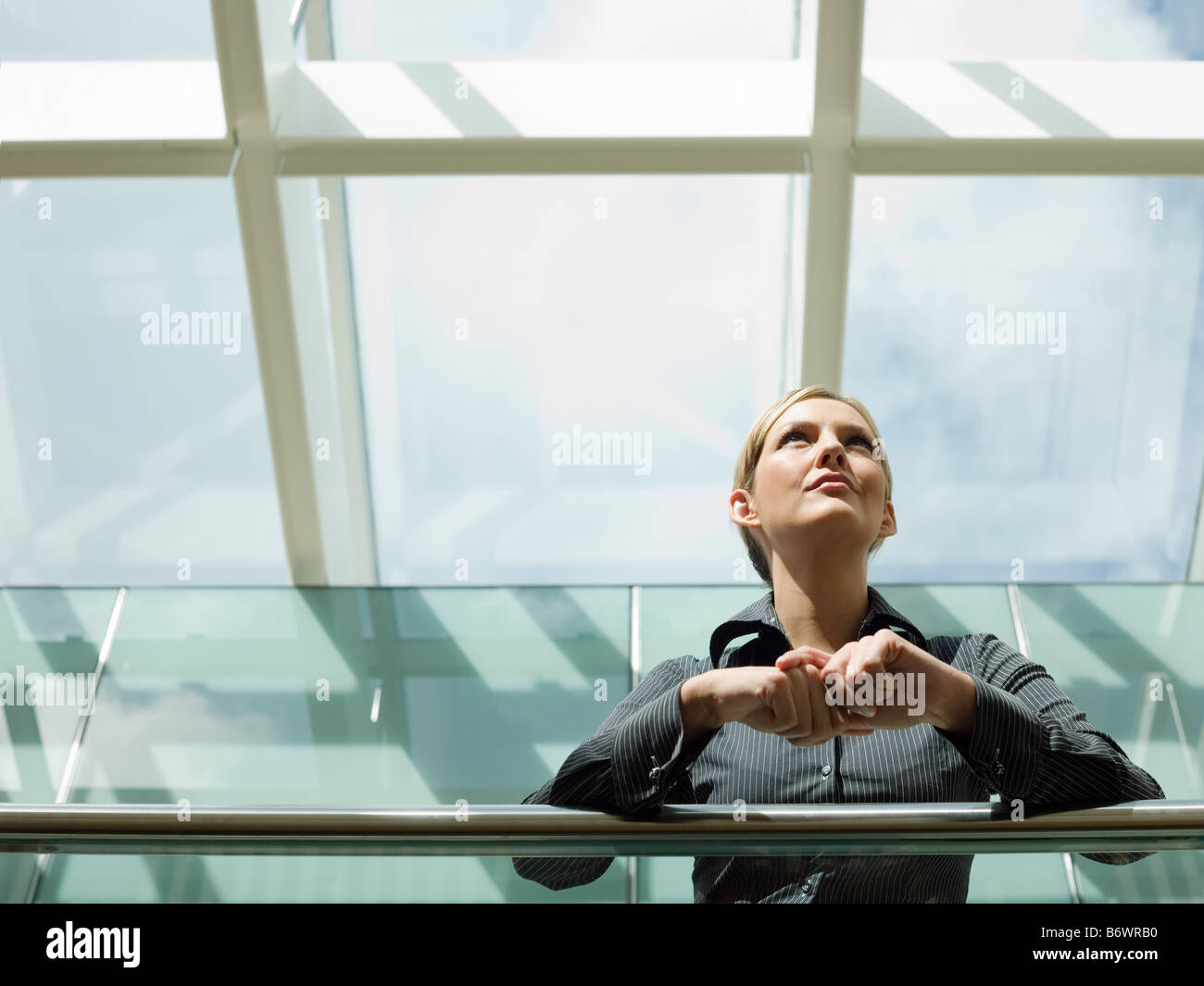 Businesswoman looking up Stock Photo - Alamy