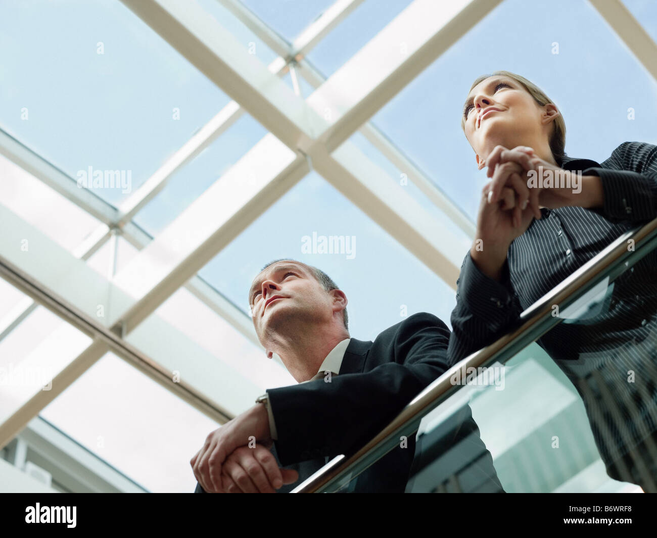 Colleagues looking up Stock Photo - Alamy