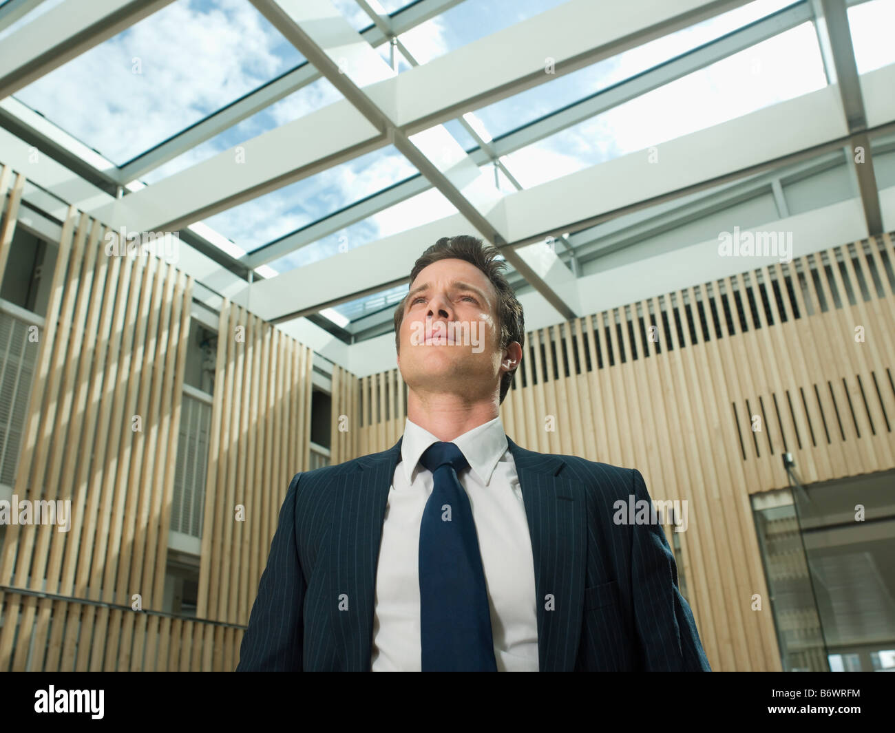 Businessman looking up Stock Photo - Alamy