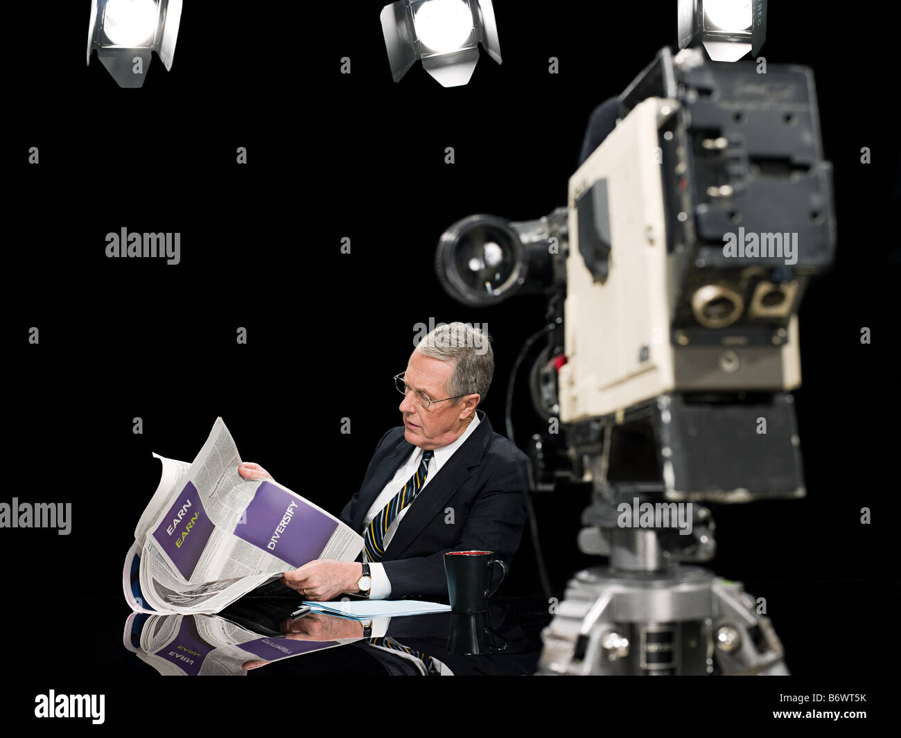 News presenter reading newspaper Stock Photo - Alamy