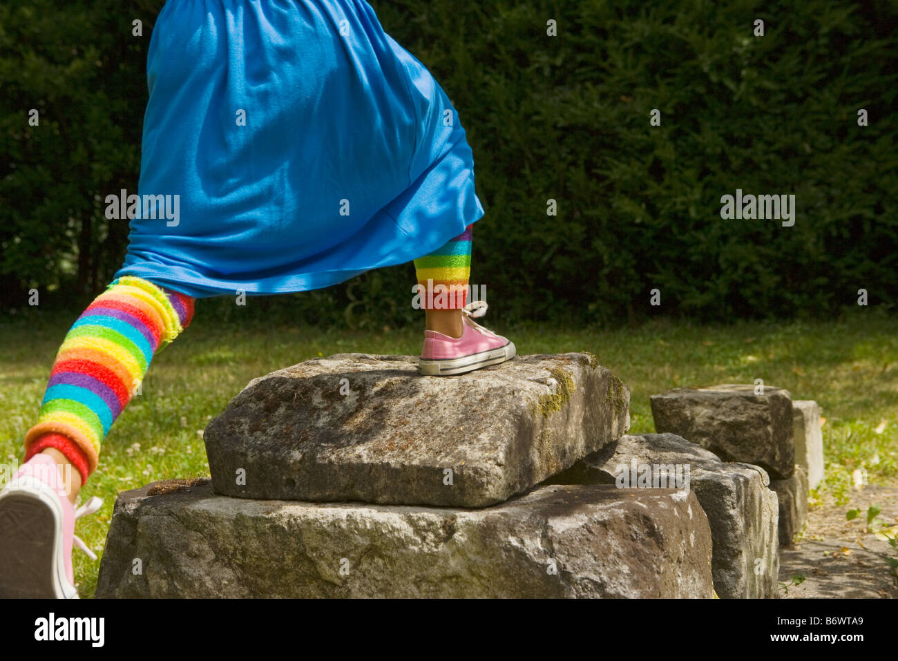 A girl stepping on rocks Stock Photo - Alamy