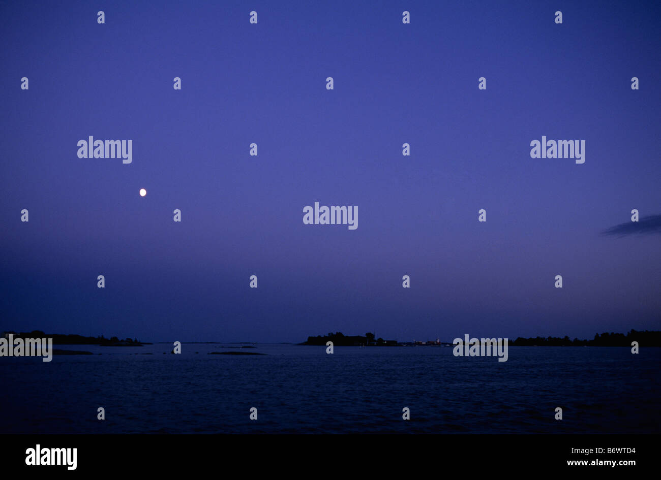 A full midnight moon shines over some of the islands that make up the ...