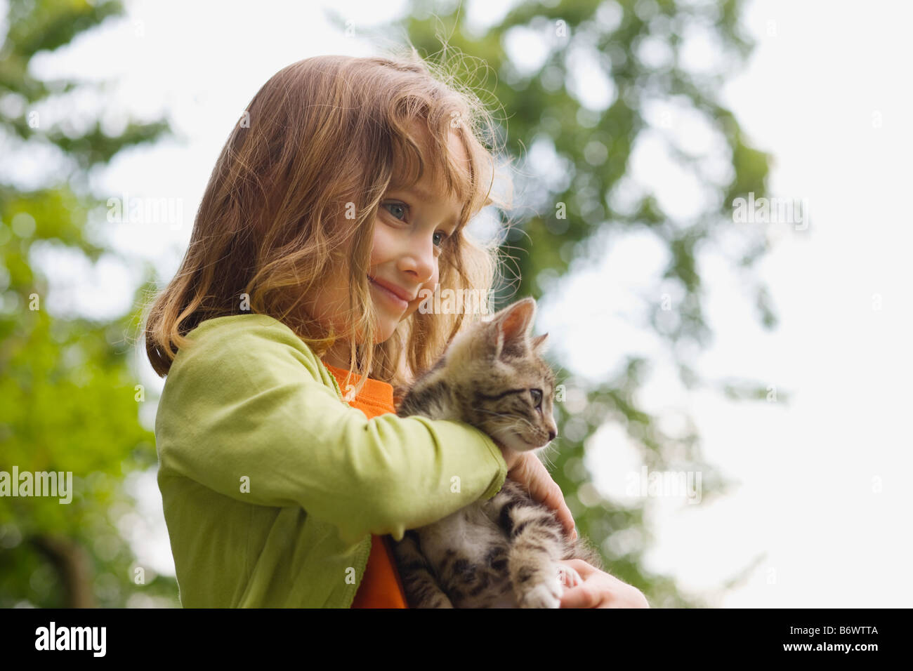 A girl holding a kitten Stock Photo - Alamy