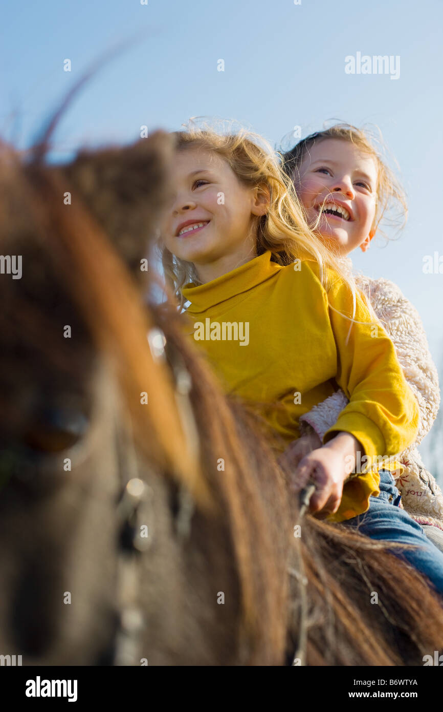 Girls riding a shetland pony Stock Photo - Alamy