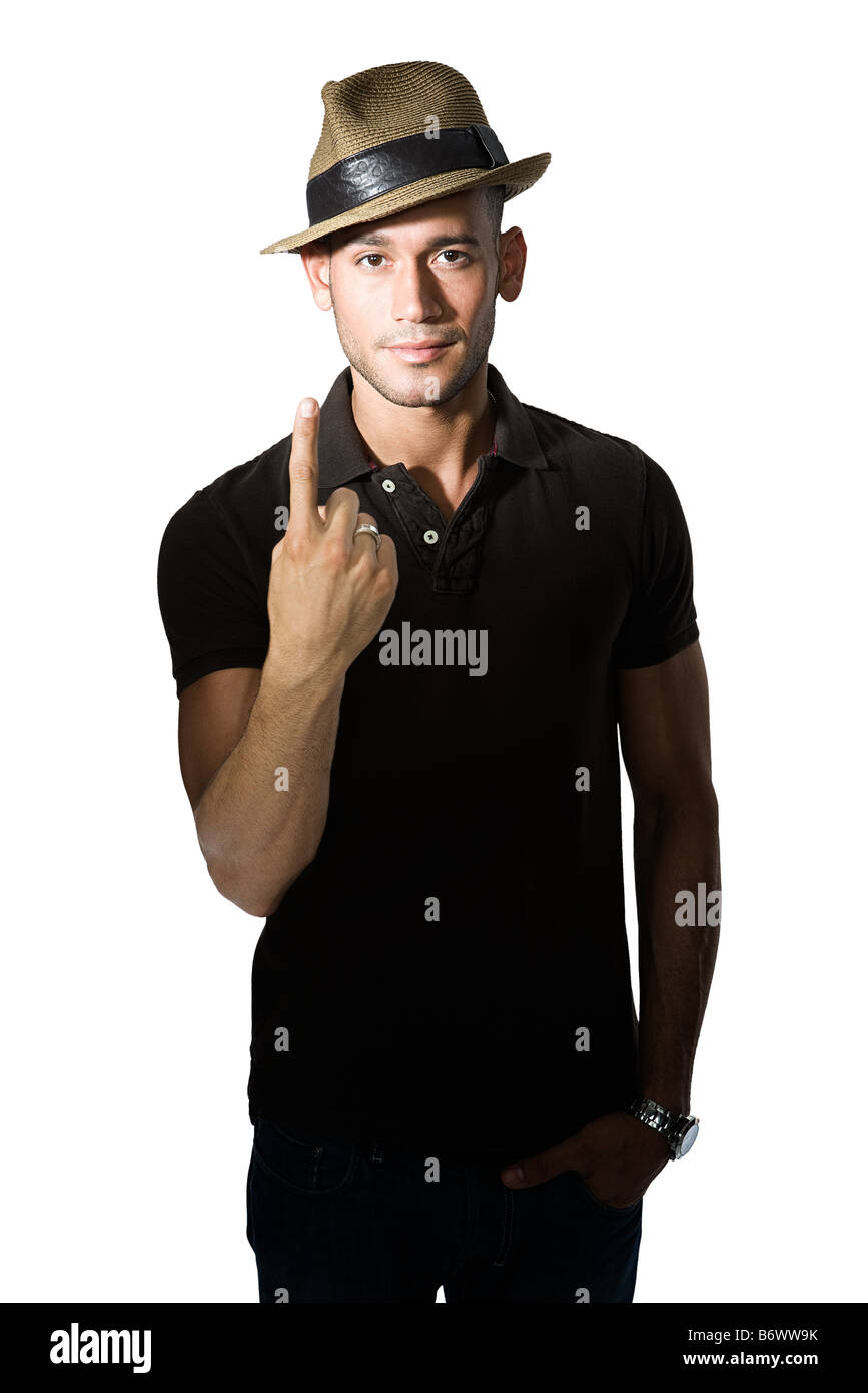 Portrait of a young man holding one finger up Stock Photo - Alamy
