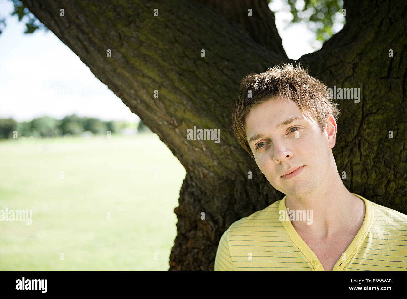 Man by a tree Stock Photo - Alamy