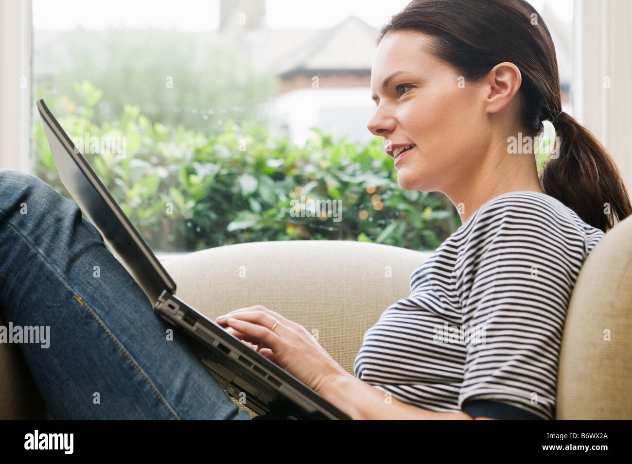 Woman with laptop Stock Photo - Alamy