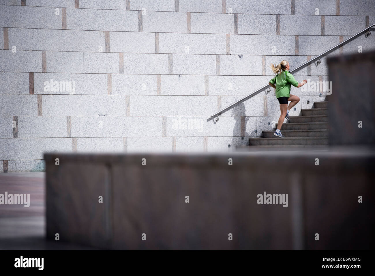A woman jogging through an urban landscape Stock Photo - Alamy