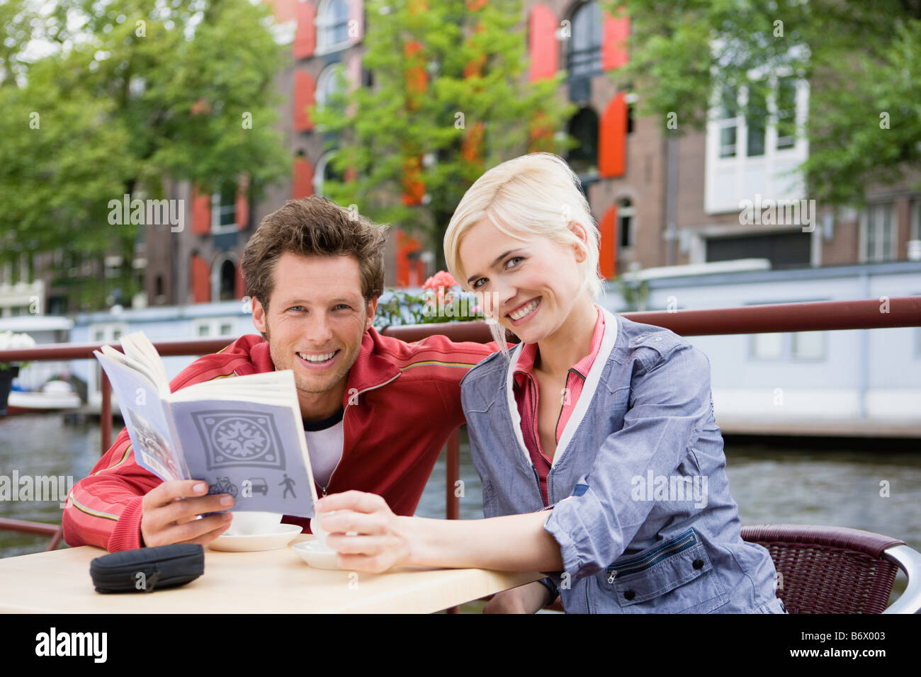 Young couple reading guidebook hi-res stock photography and images - Alamy