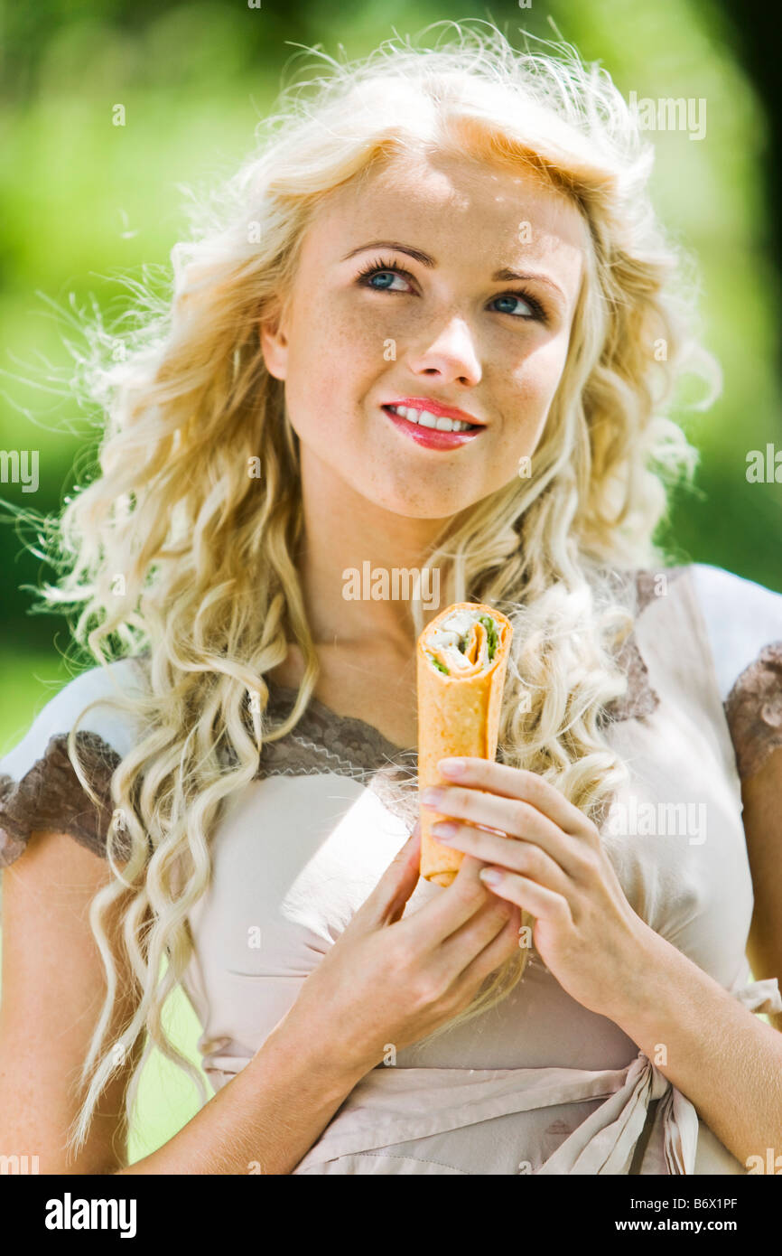 Young woman eating enchilada Stock Photo - Alamy