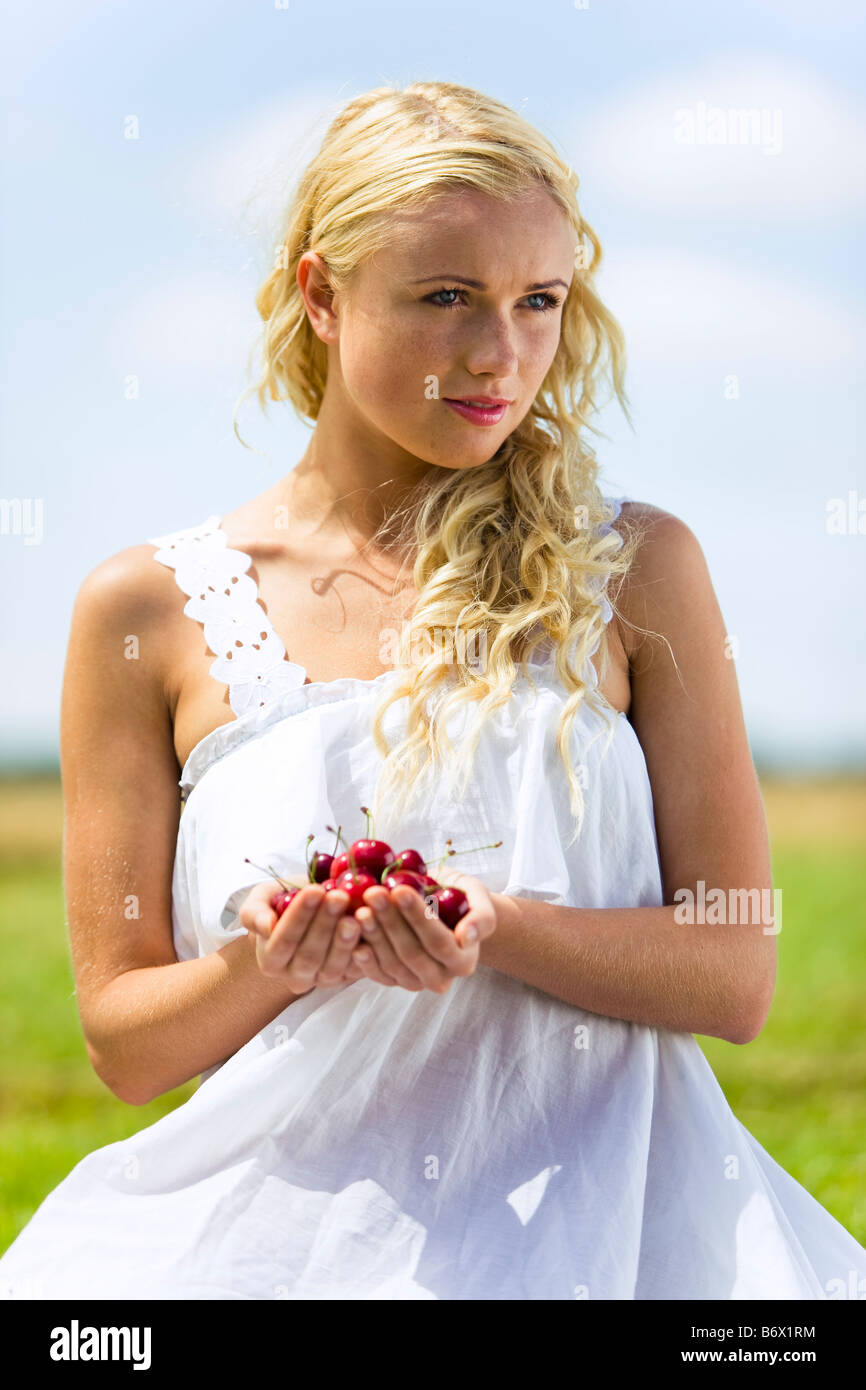 Portrait of young woman with cherries Stock Photo - Alamy