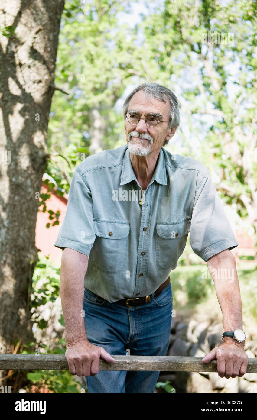 Man standing by railing Stock Photo - Alamy