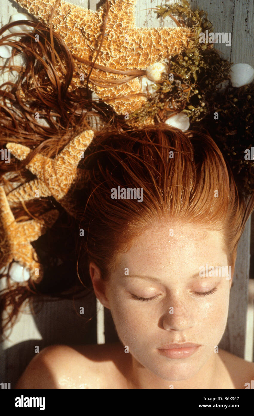 Young woman lying outdoors, sunbathing Stock Photo - Alamy