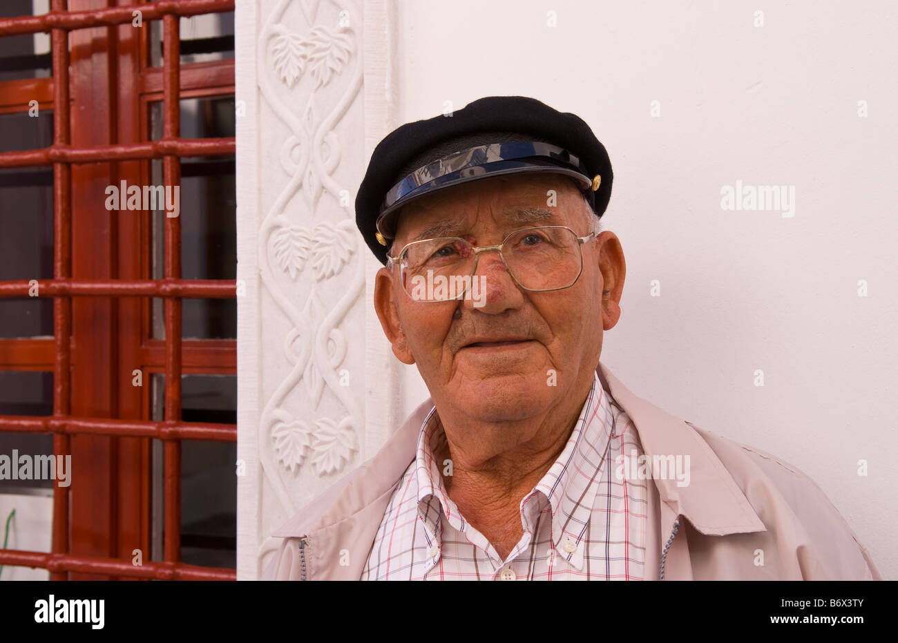 Local man in Greek hat in downtown Mykonos Greece in Greek Islands of ...