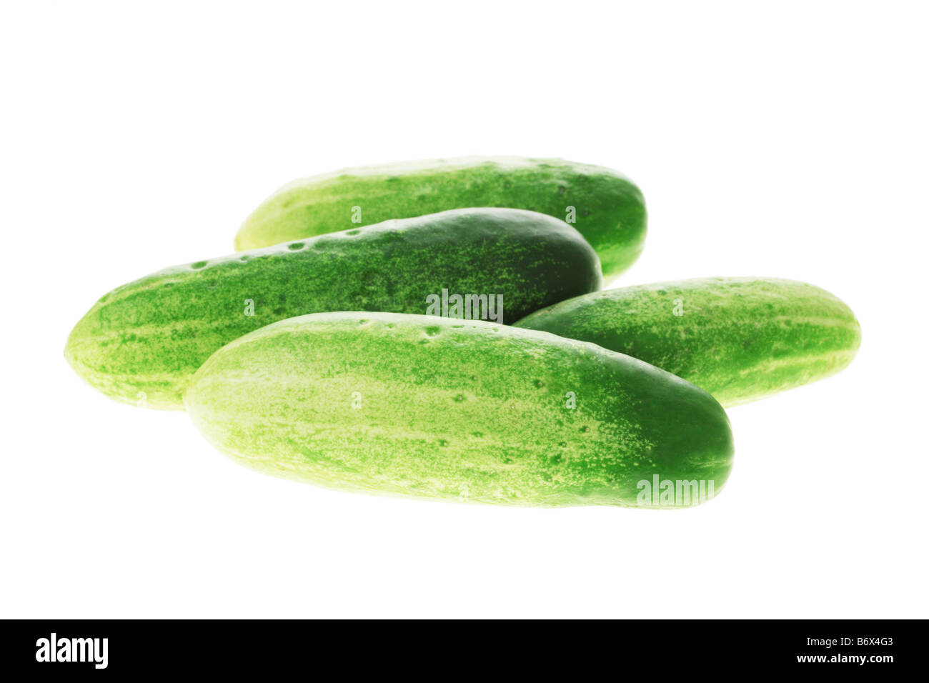 Four fresh cucumbers on white background Stock Photo - Alamy