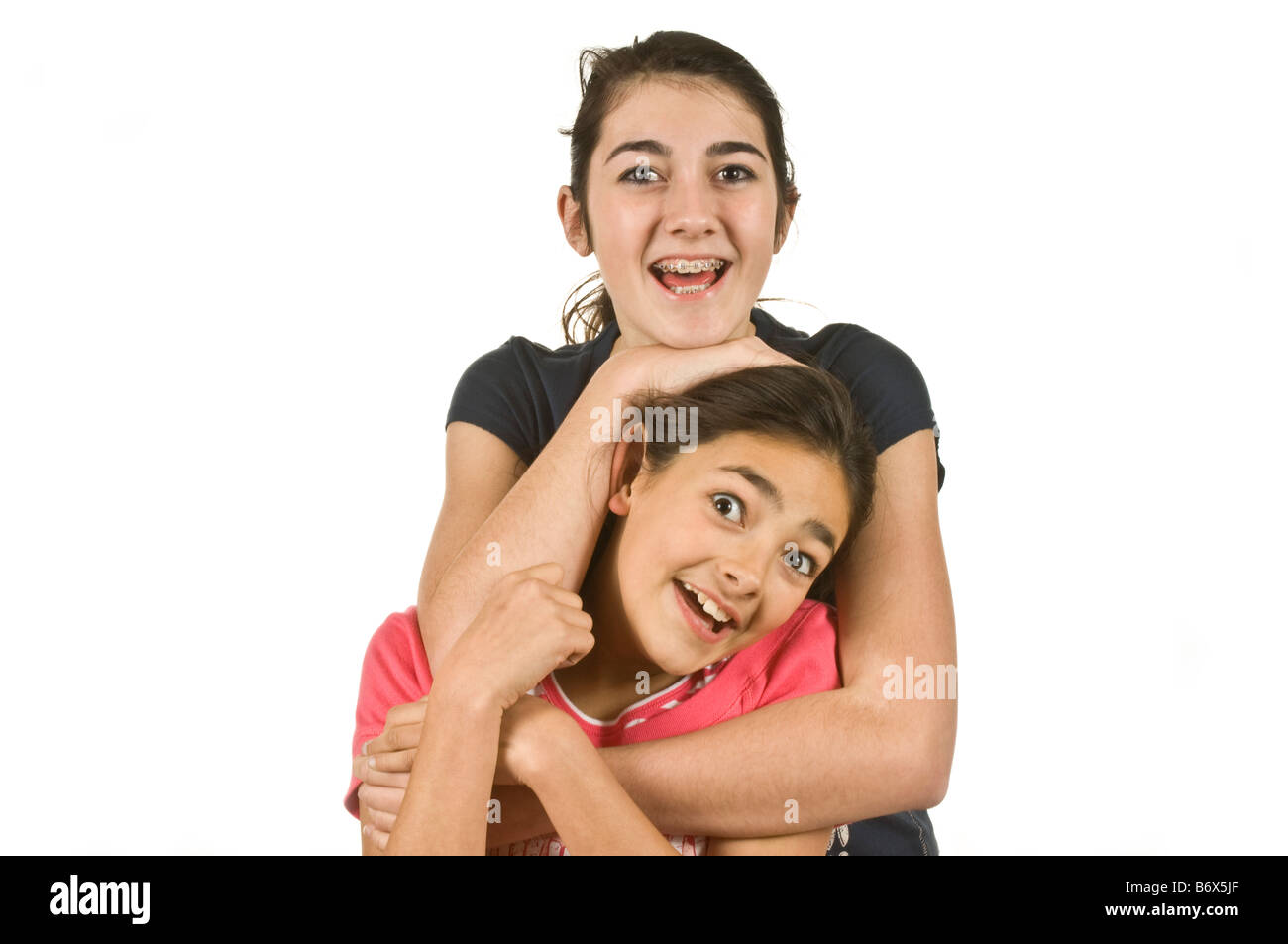A portrait of 2 girls (11 and 14) sisters and best friends against a ...