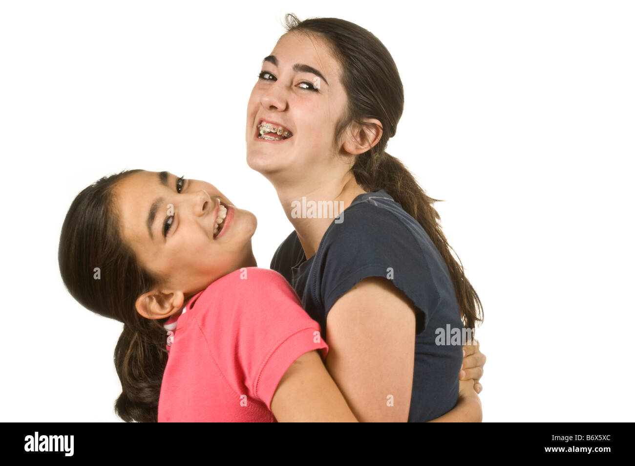 A portrait of 2 girls (11 and 14) sisters and best friends against a ...