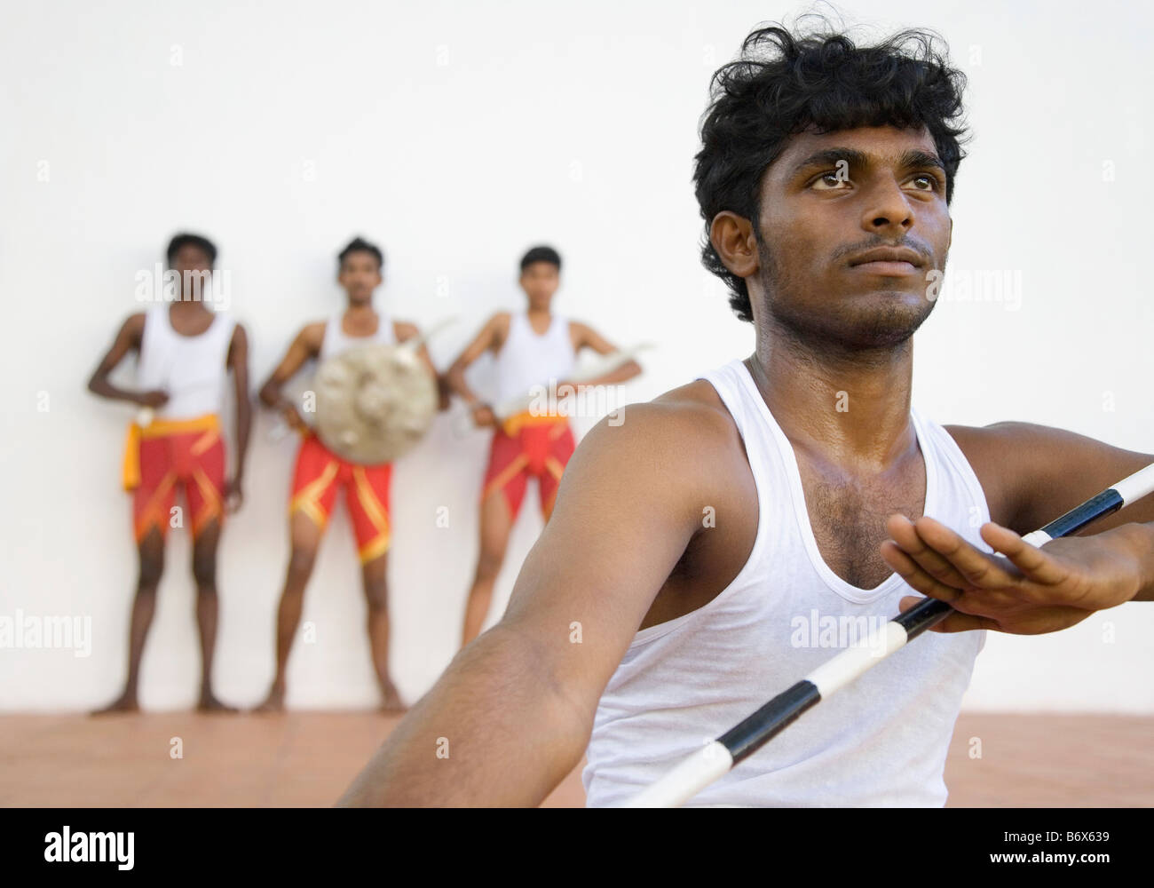Close-up of a teenage boy holding a long staff Stock Photo - Alamy