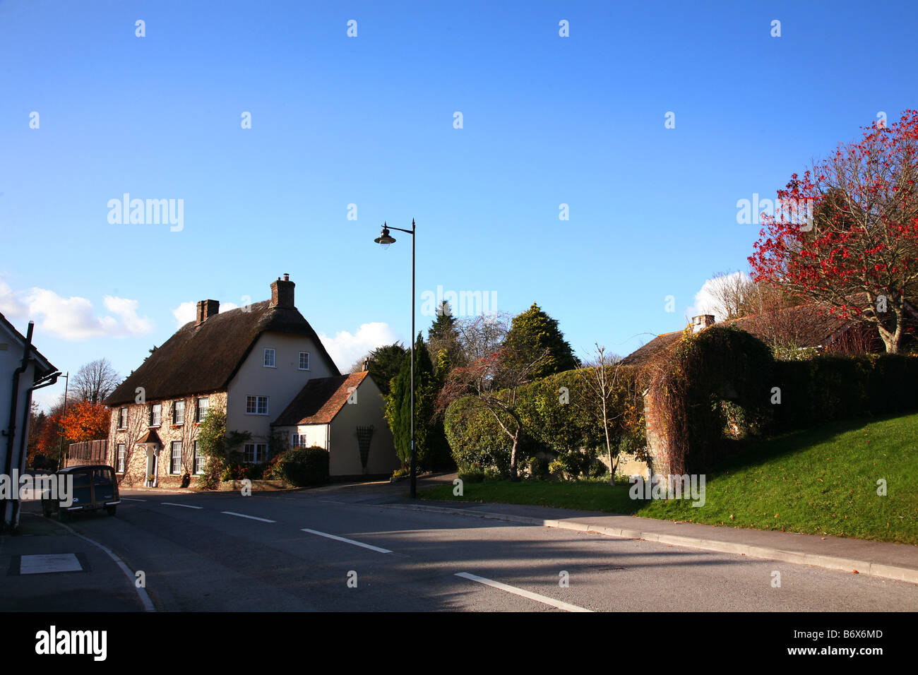 Thatched cottages on the main street through the Dorset village of ...