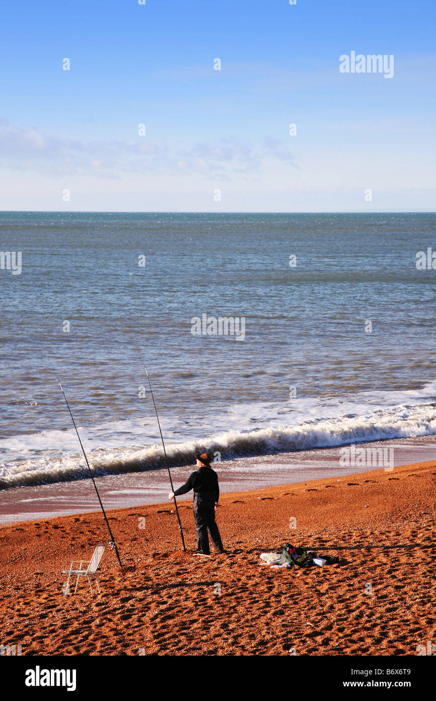 Fisherman on the shingle beach at Seatown, a hamlet near Chideock ...