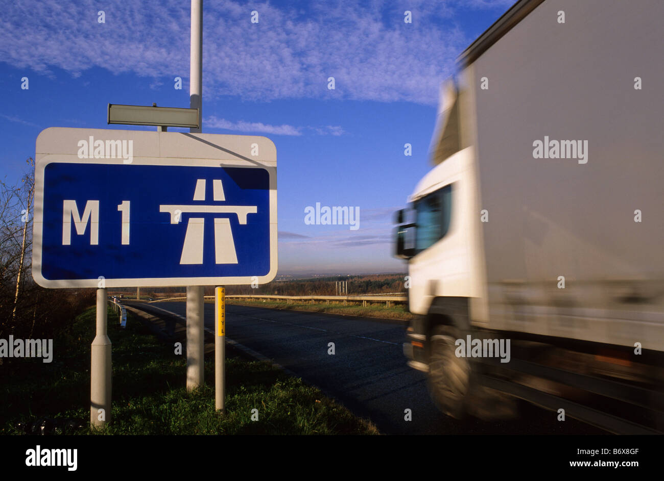 lorry passing road sign stating start of M1 motorway near Leeds ...