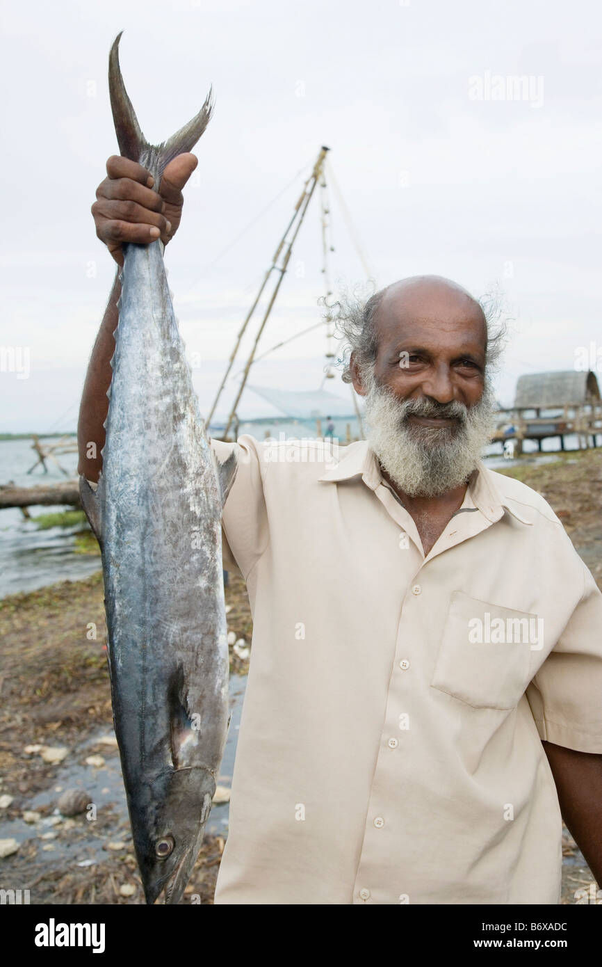 Fishermen holding a fish, Cochin, Kerala, India Stock Photo - Alamy