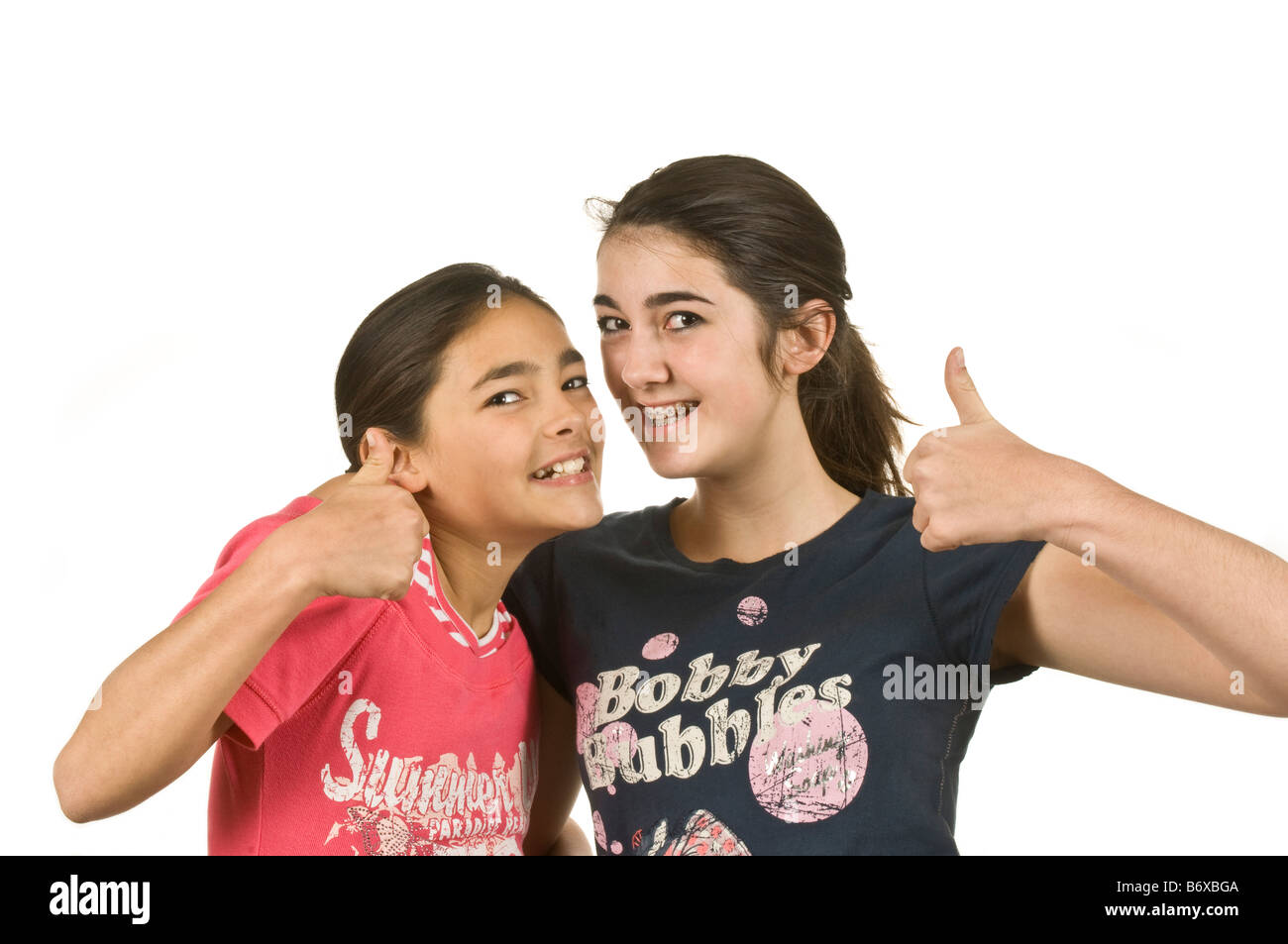 A portrait of 2 girls (11 and 14) sisters and best friends against a ...
