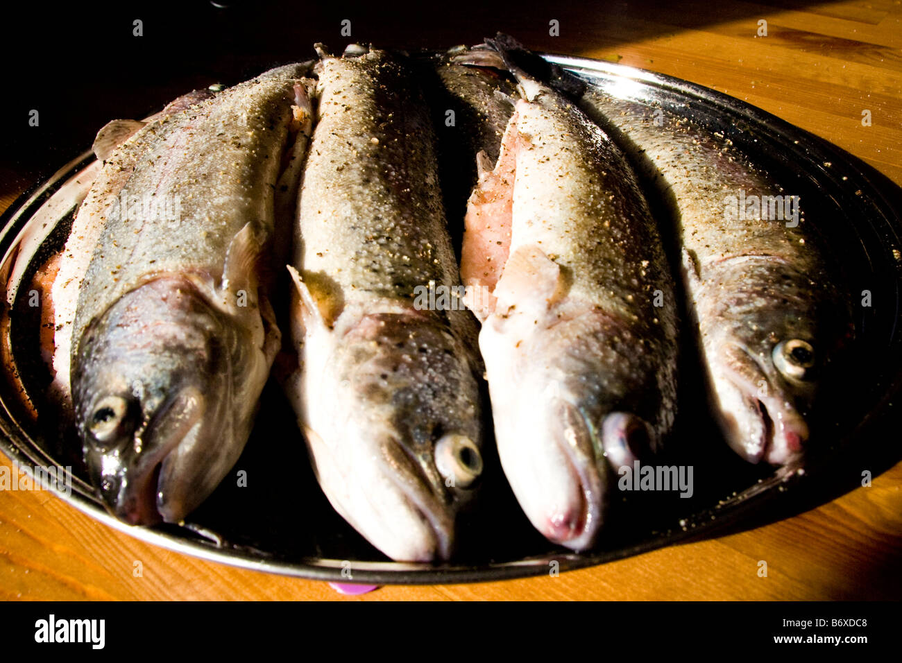Four fresh trout on a silver platter Stock Photo - Alamy