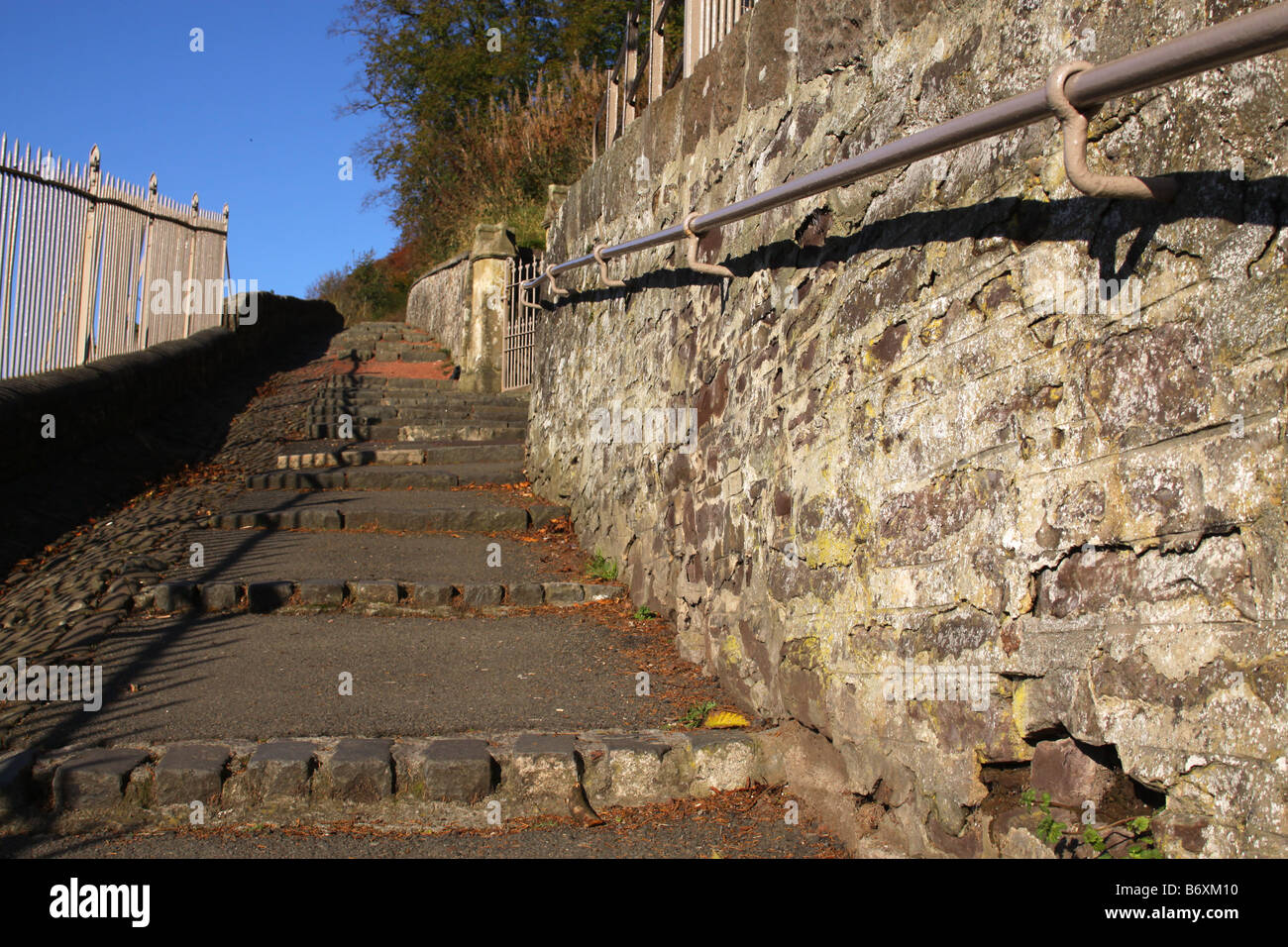 Stone steps with handrail and fence Stock Photo - Alamy