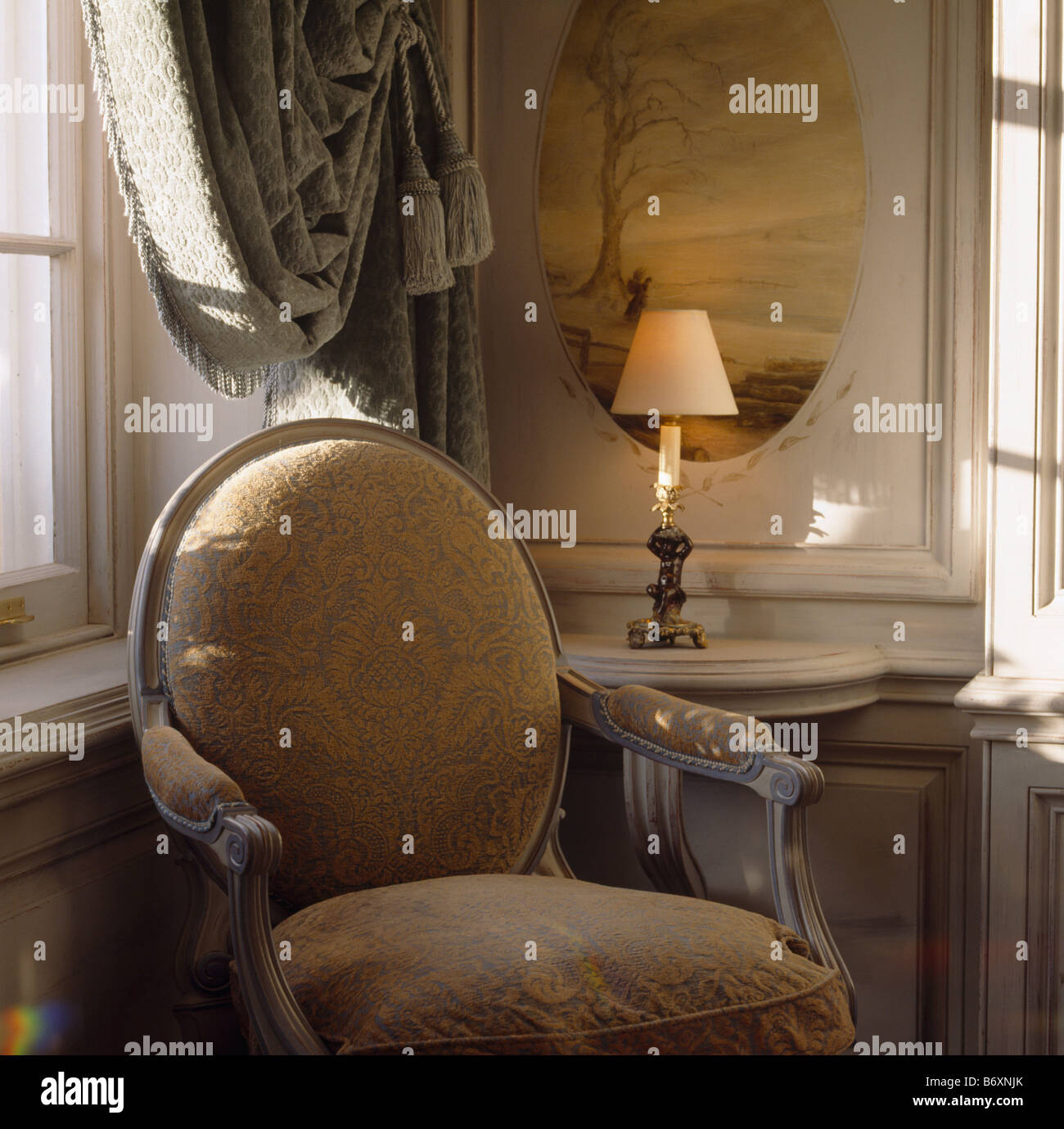 Painted panel and lighted lamp on console table behind Louis IV style ...