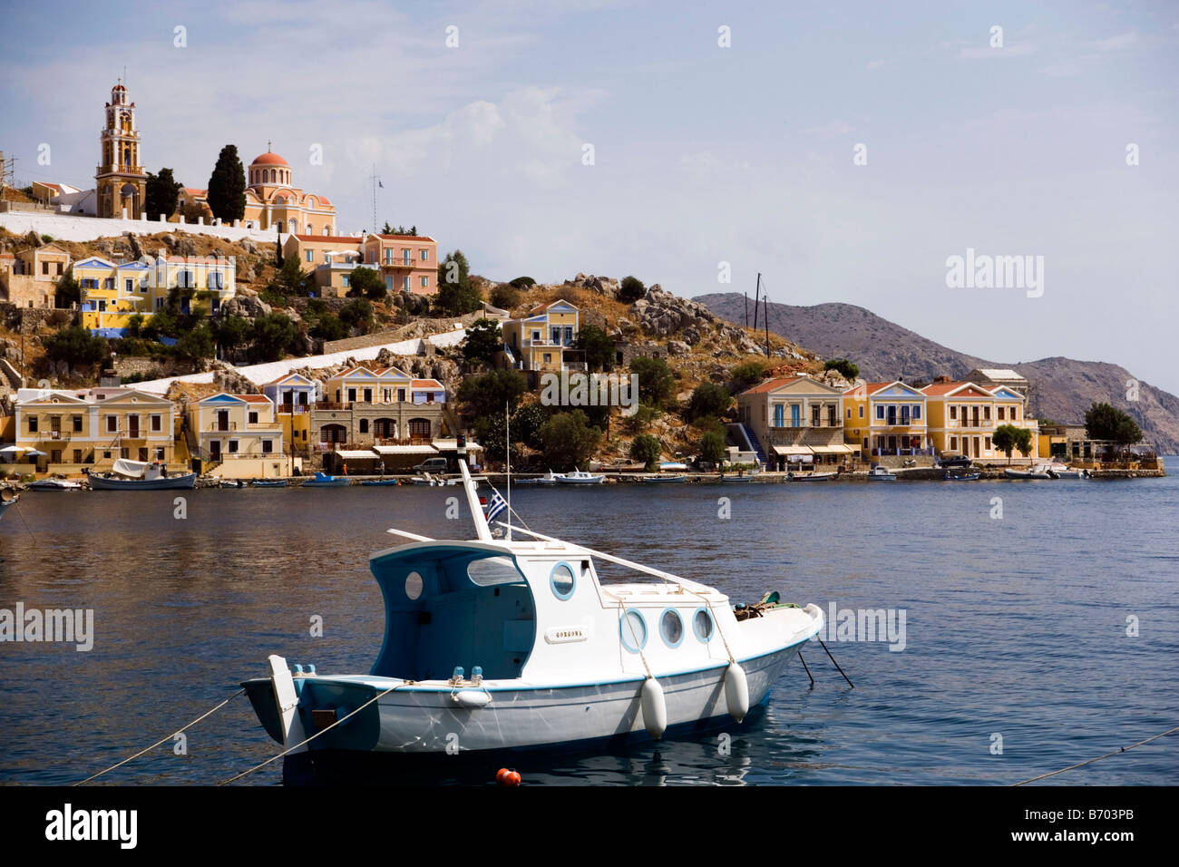 Motorboat anchoring in harbour gialos hi-res stock photography and ...