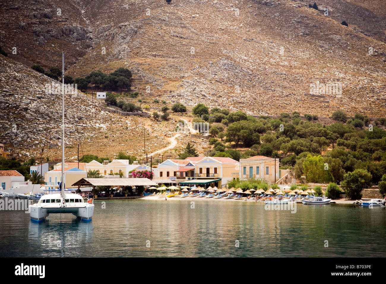 Sailing catamaran anchoring near beach, Pedi, Symi Island, Greece Stock ...