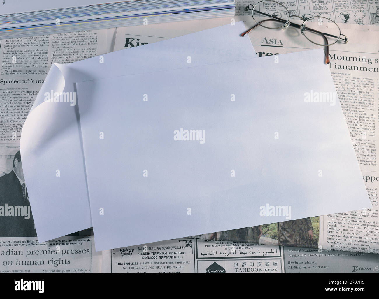 White papers on the newspaper Stock Photo - Alamy