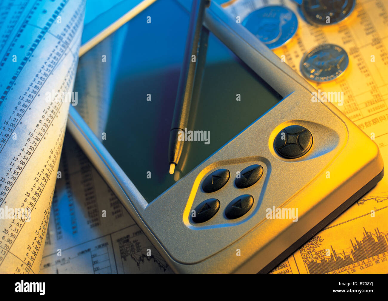 PDA, coins and newspaper Stock Photo - Alamy