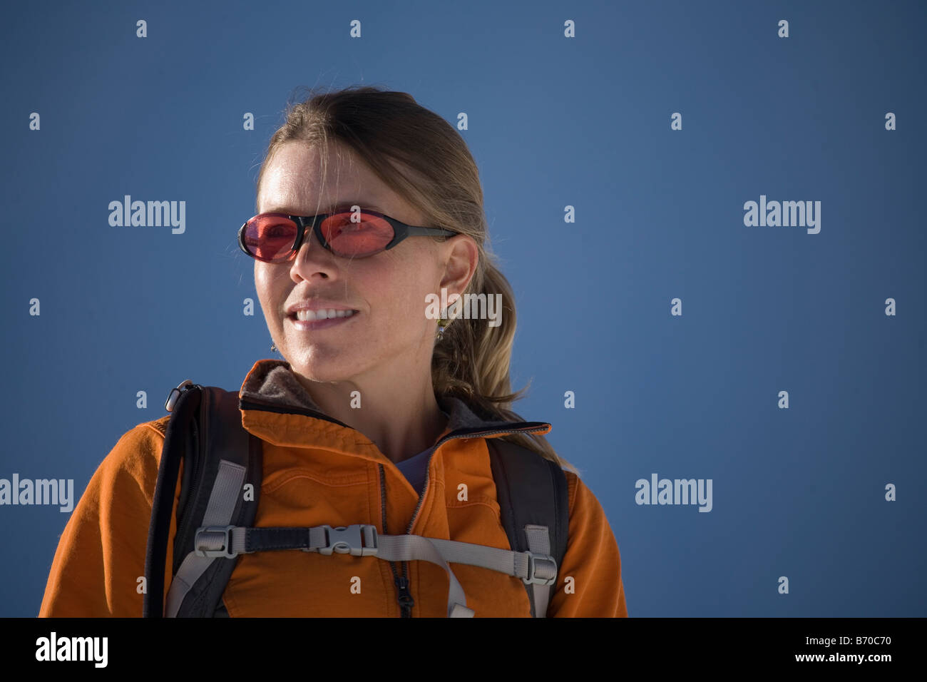 Woman smiles with backpack Stock Photo - Alamy