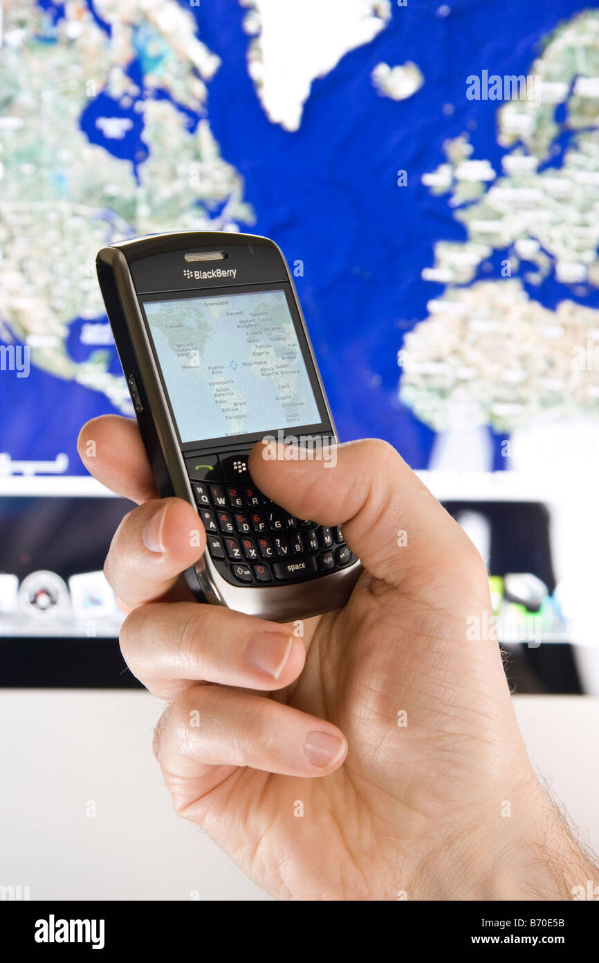 Blackberry handshot in front of monitor Stock Photo - Alamy