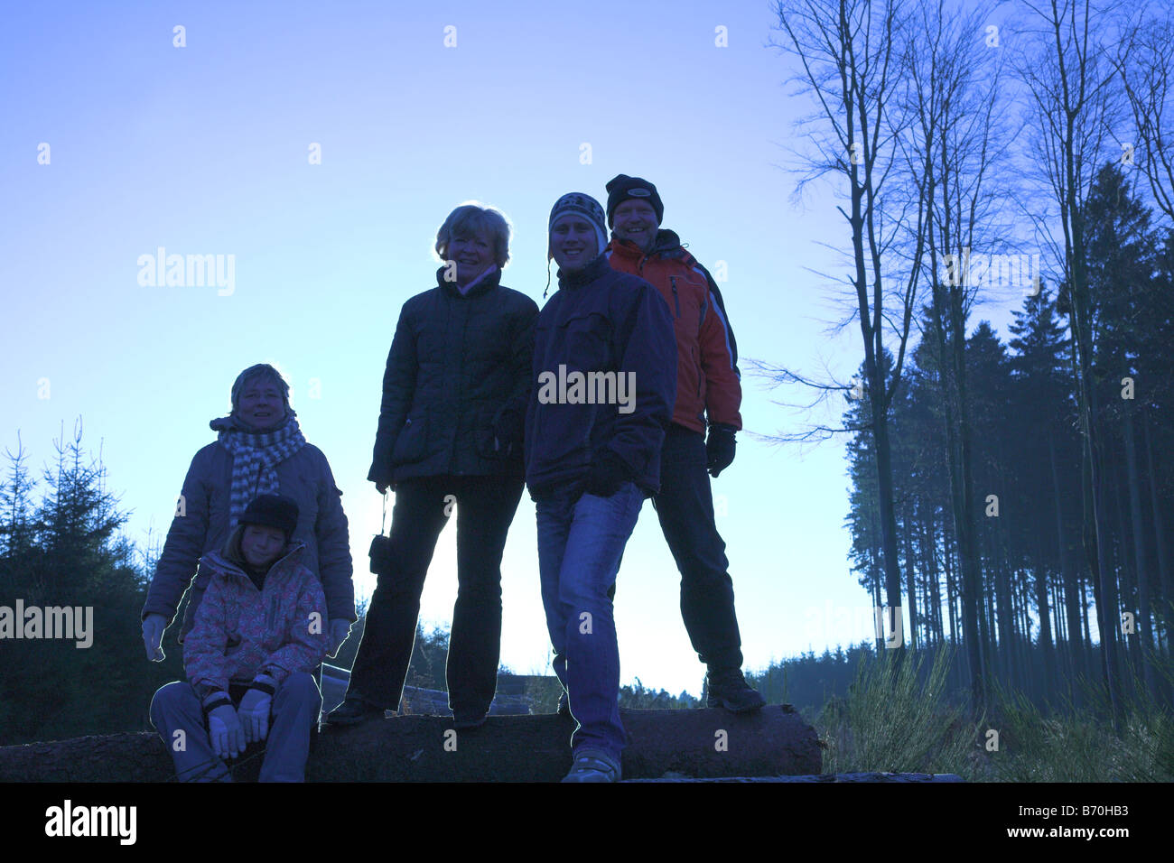 Family group pose for a photograph on a bitterly cold winters evening ...