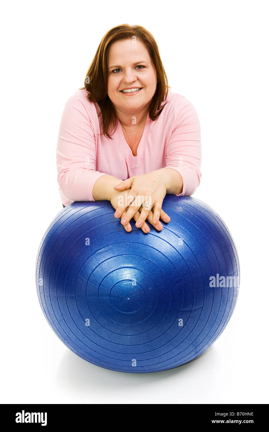 Beautiful plus sized model in workout clothes leaning on a pilates ball ...