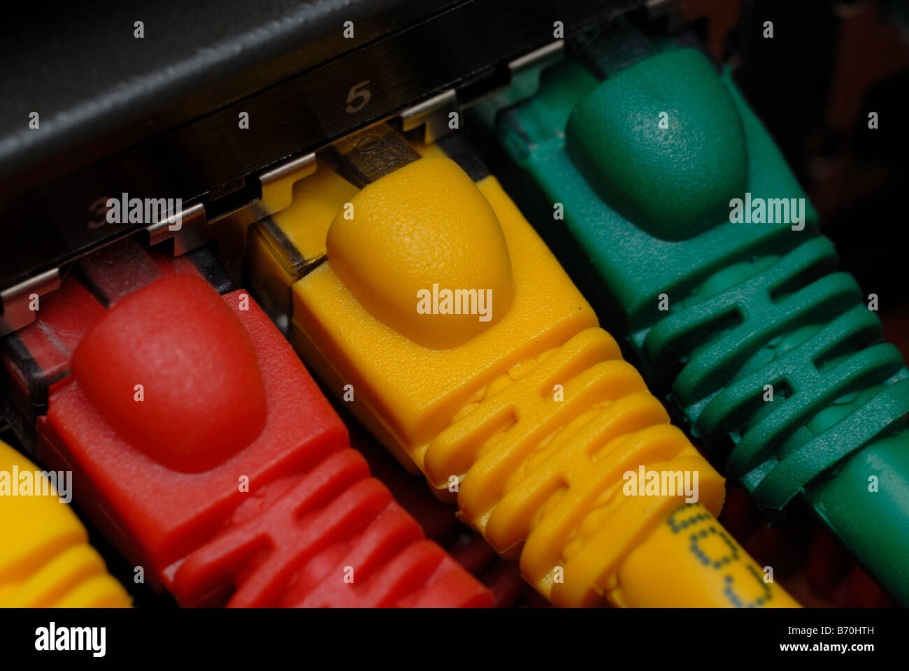 Brightly colored ethernet cables plugged into a network router Stock ...