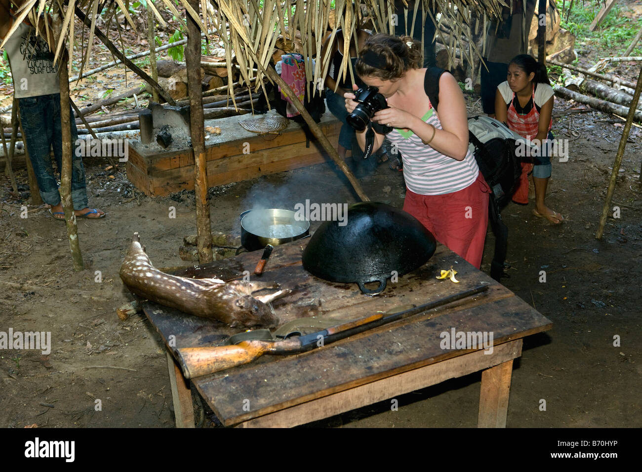 Suriname, Kwamalasamutu, Tourist making picture of hunted paca ( Agouti ...