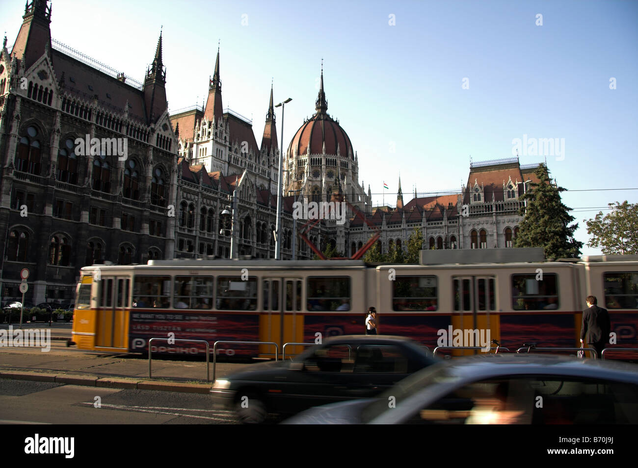 Yellow tram outside the Hungarian Parliament building, Pest, Budapest ...