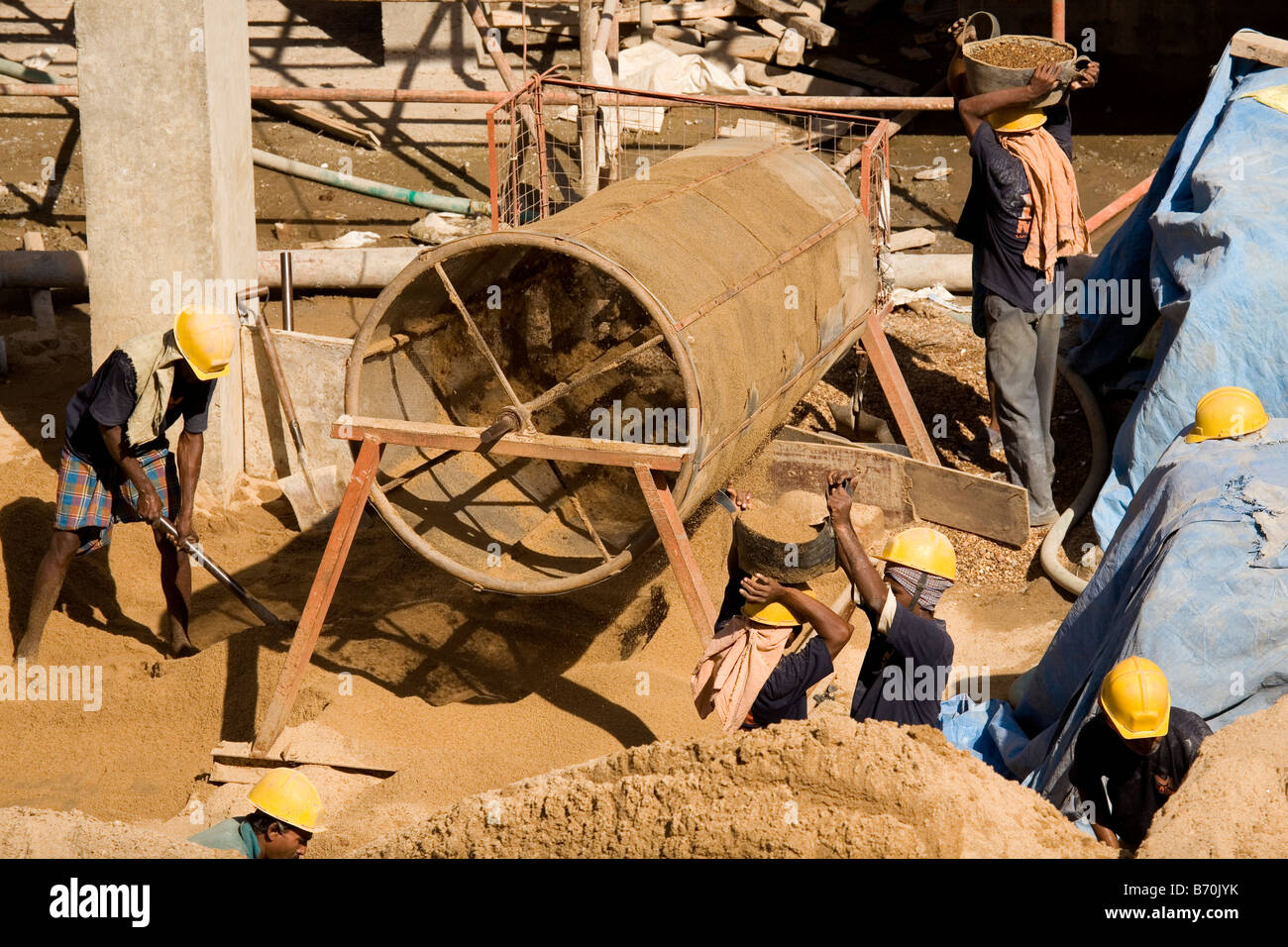 Construction workers work on a building site in the south Indian city ...