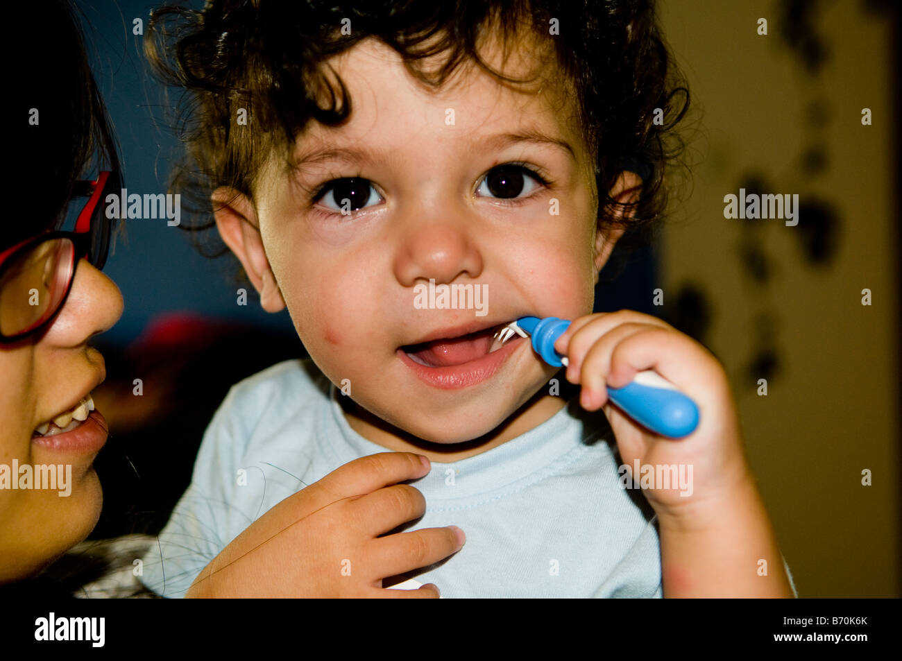 A 15 month young boy brushes her teeth Stock Photo - Alamy